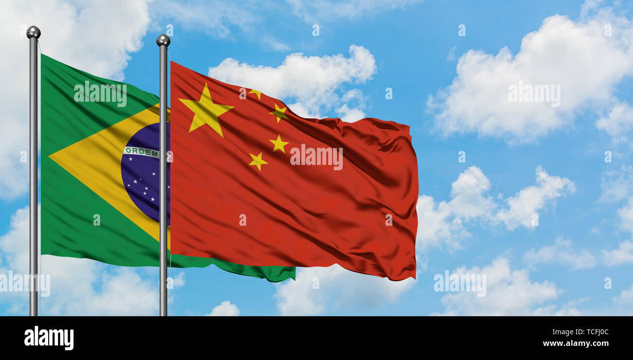 Brazil and China flag waving in the wind against white cloudy blue sky ...