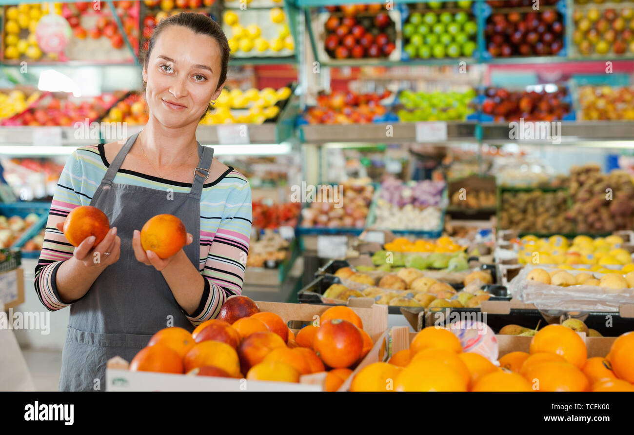 Happy cheerful positive smiling Caucasian female store employee at ...