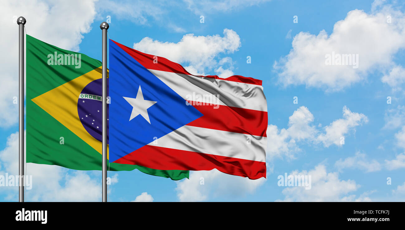 Brazil and Puerto Rico flag waving in the wind against white cloudy ...