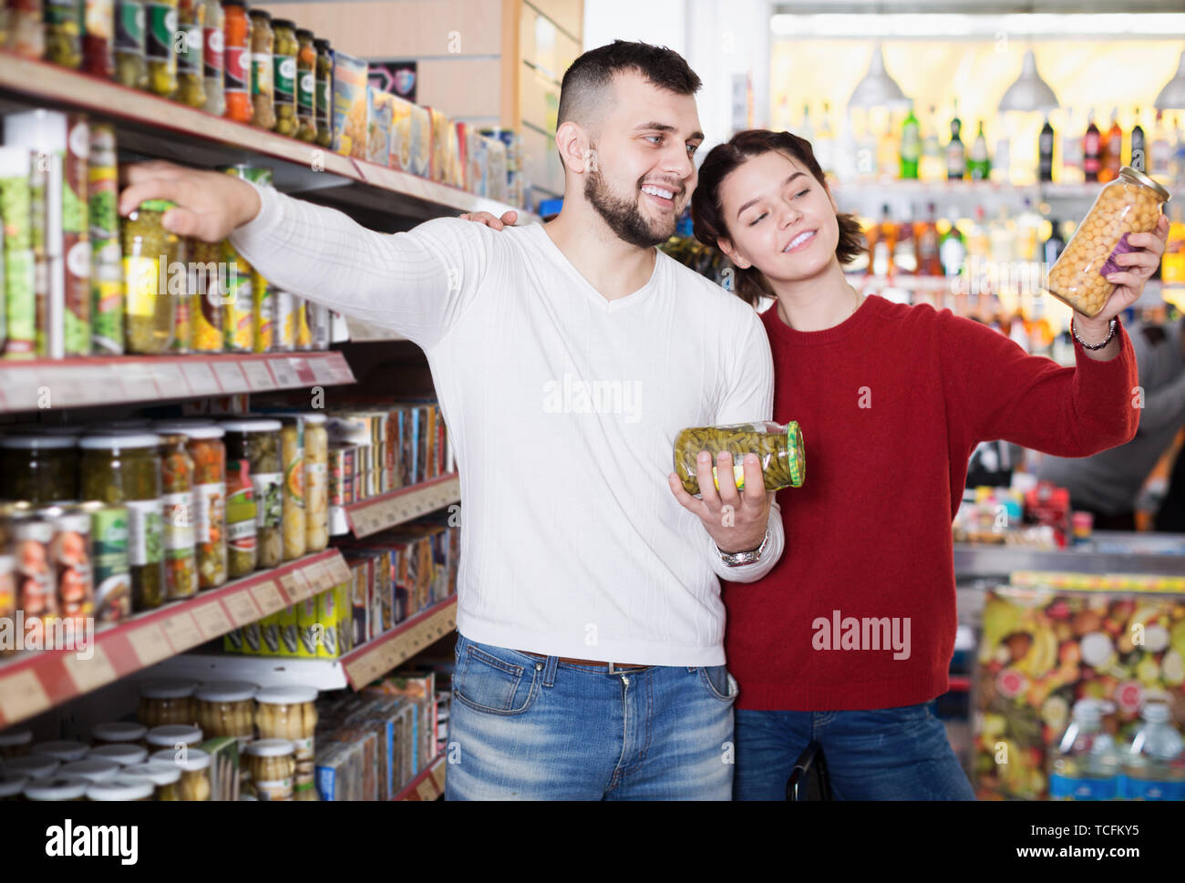 Ordinary couple purchasing tinned food at grocery supermarket Stock ...
