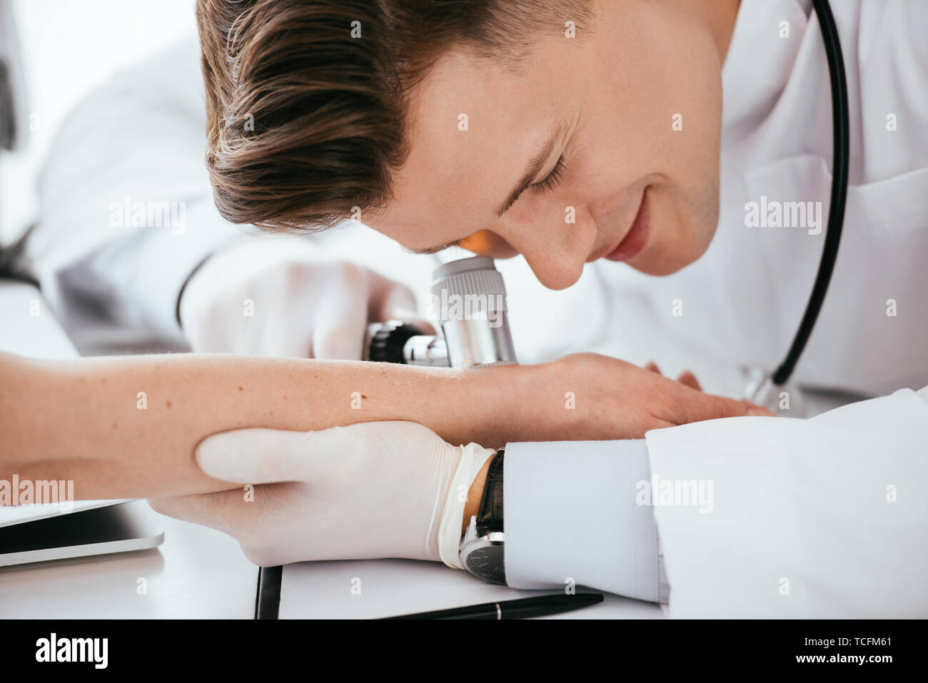 Examining hand hi-res stock photography and images - Alamy