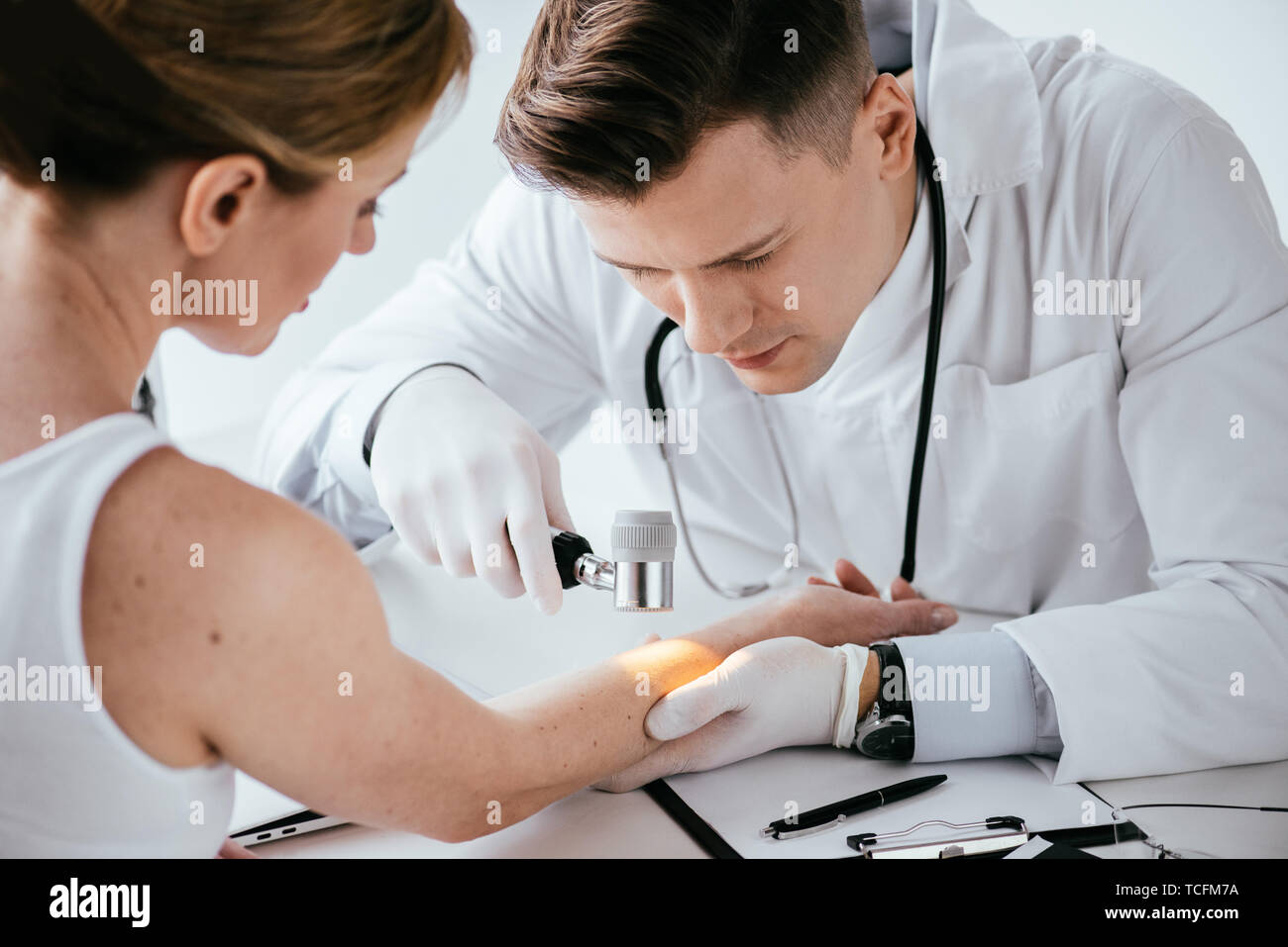 Examining hand hi-res stock photography and images - Alamy