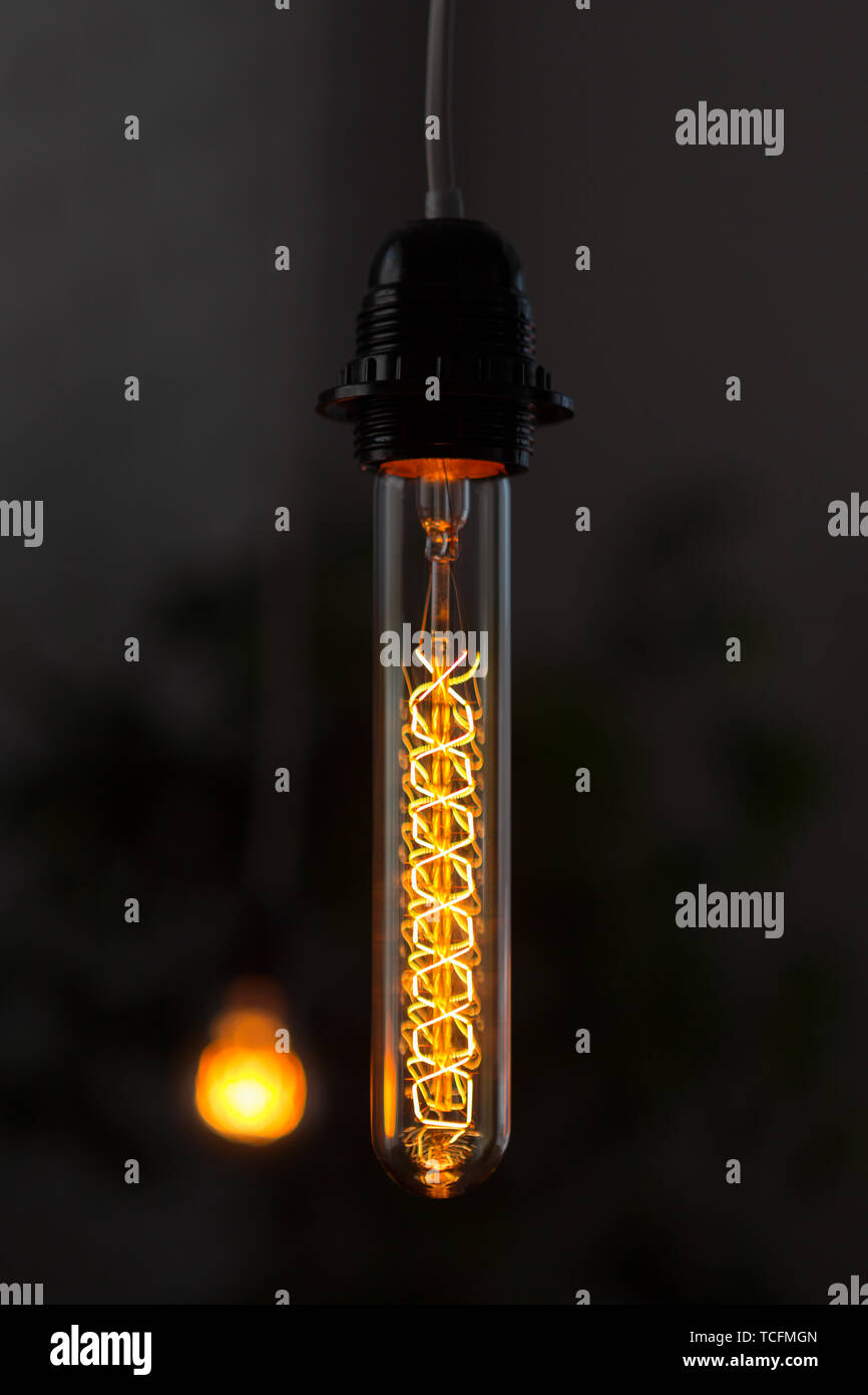 A classic Edison light bulb on dark background with space for text ...