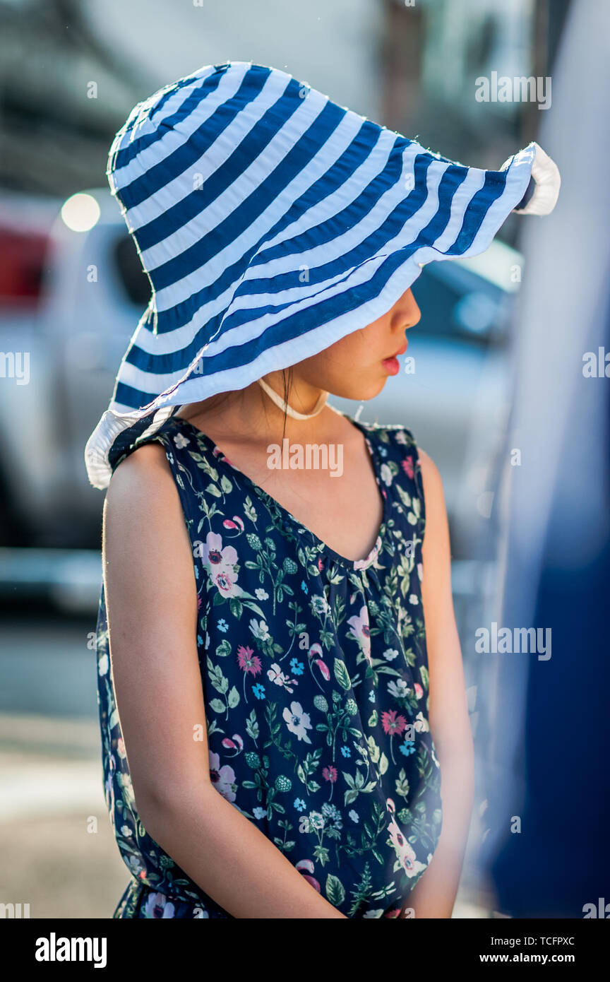 A young Asian girl wearing a pretty sun hat enjoys the scenery at The ...