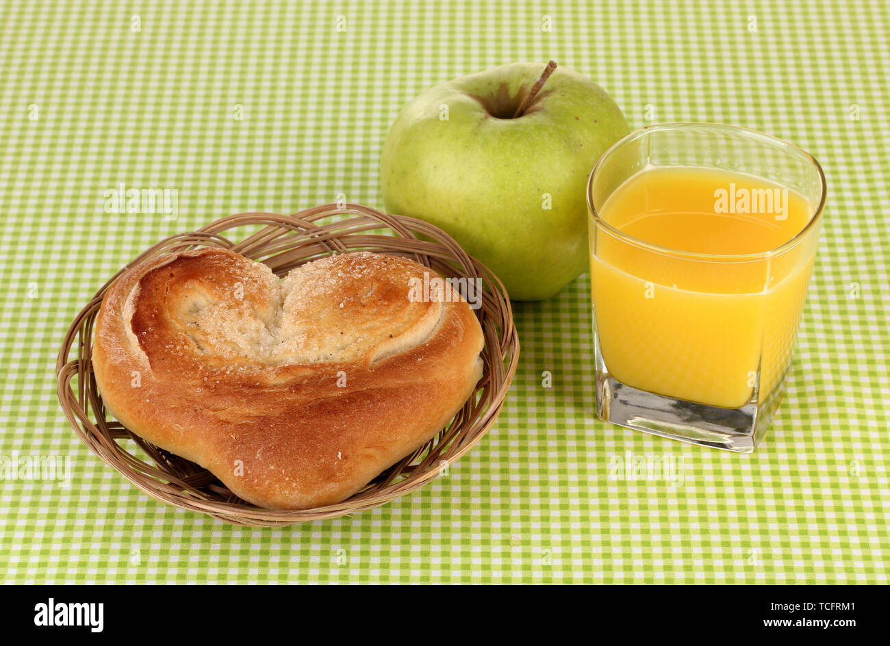 Classical breakfast. Orange juice and bun Stock Photo - Alamy