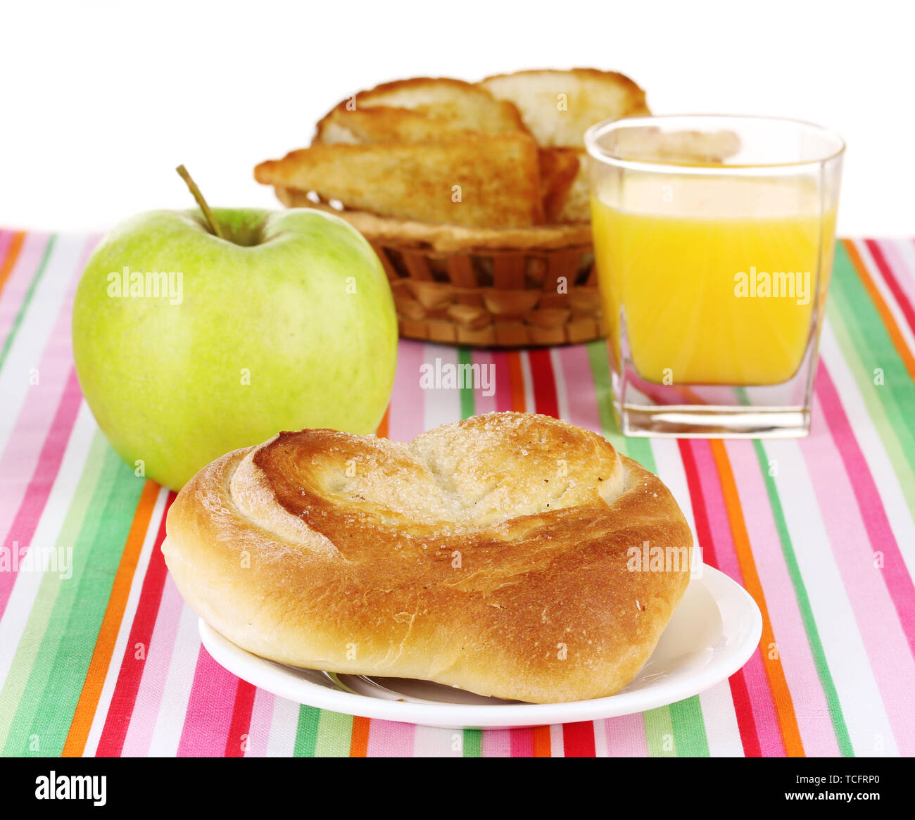 Classical breakfast. Orange juice and bun Stock Photo - Alamy
