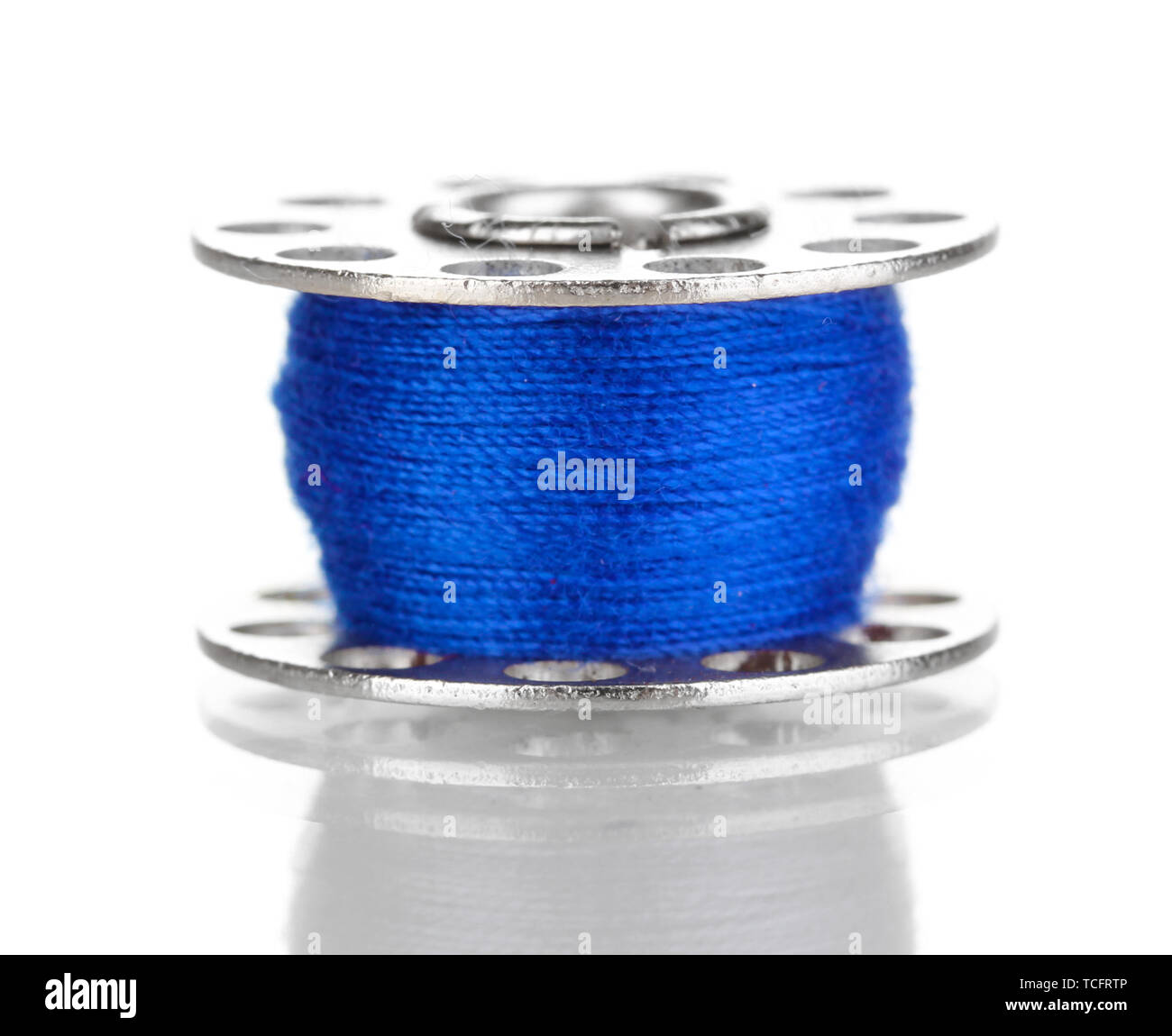 Metal spool of thread isolated on white Stock Photo - Alamy