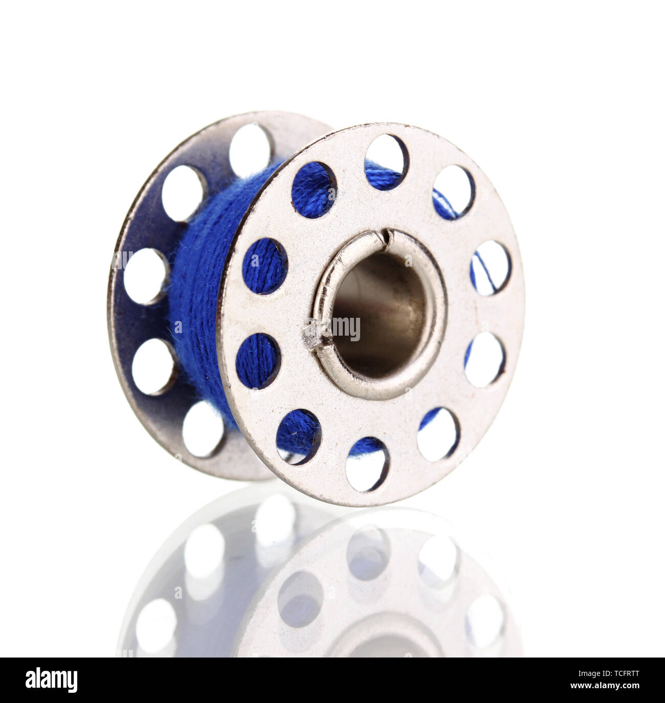 Metal spool of thread isolated on white Stock Photo - Alamy