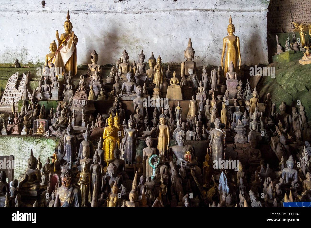 Hundreds of old and faded Buddha statues inside the Tham Ting Cave at ...