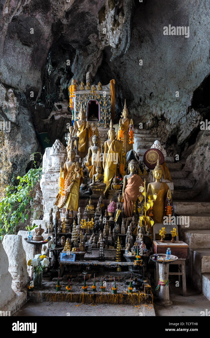 Hundreds of old and faded Buddha statues inside the Tham Ting Cave at ...