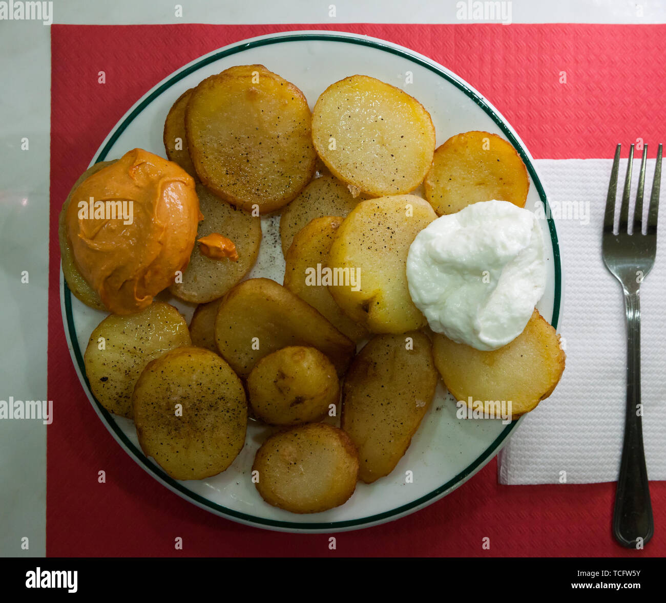 Dish of Spanish cuisine Patatas Bravas – fried potato with spicy sauces ...