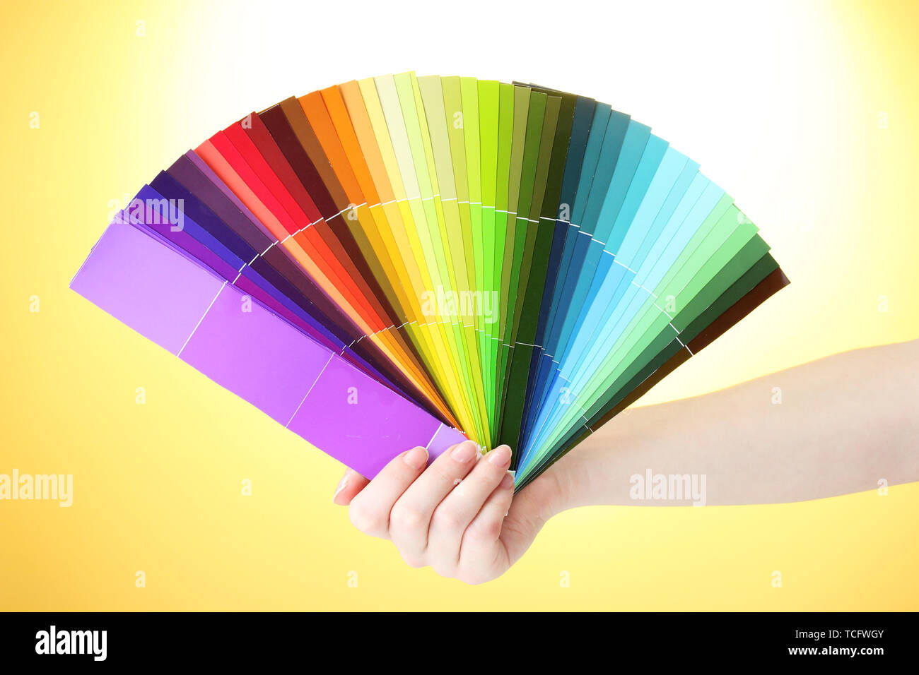 hand holding bright palette of colors on yellow background Stock Photo ...