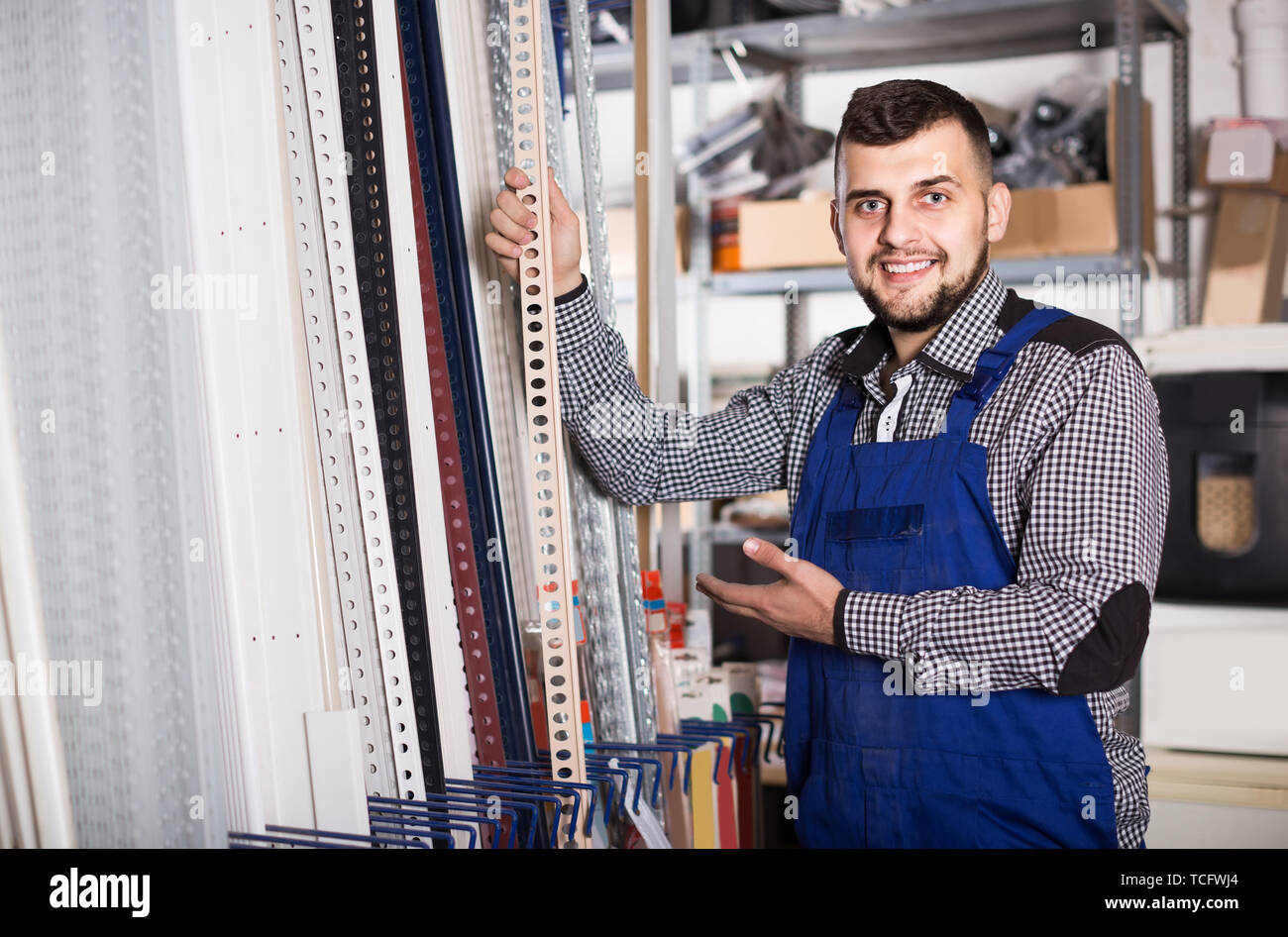 PVC industry adult worker in coverall with window and door profiles ...