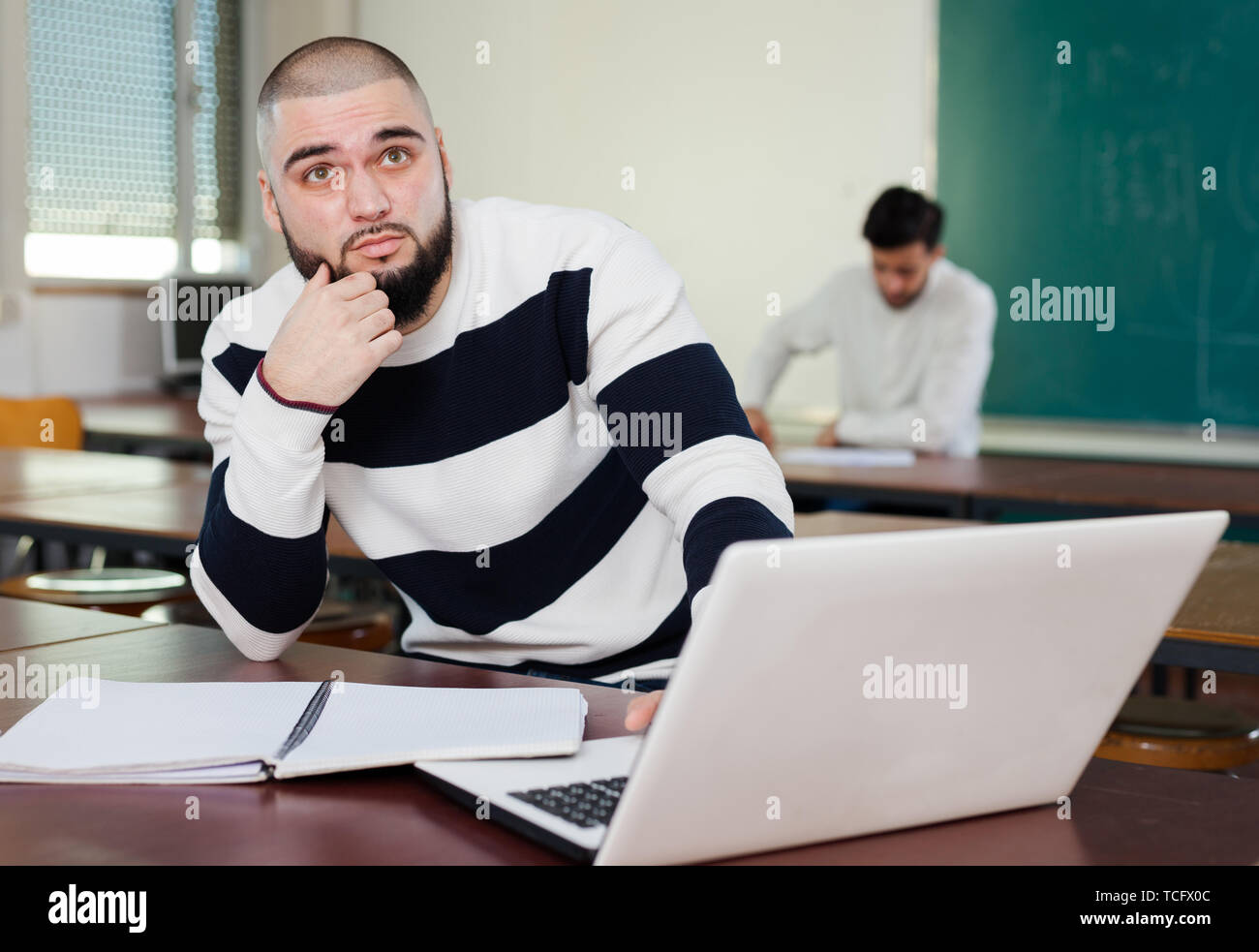 Portrait of young Arabic university student preparing for exams at ...
