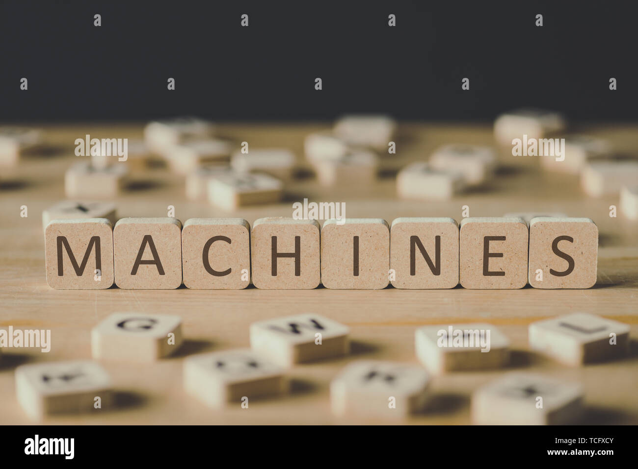 selective focus of machines lettering on cubes surrounded by blocks ...