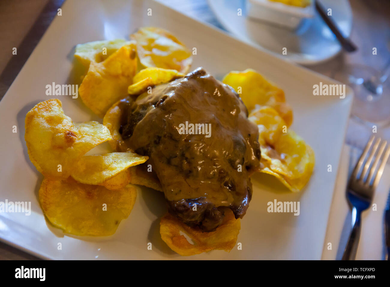 Dish of Spanish cuisine – pork cheeks in red wine Stock Photo - Alamy