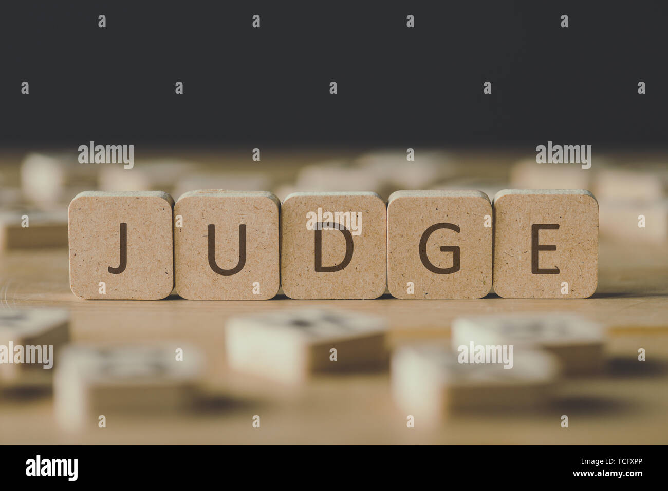 selective focus of word judge made of cubes surrounded by blocks with ...