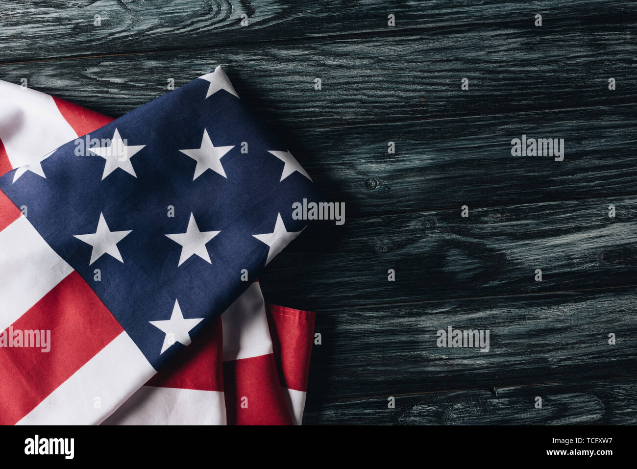 folded national flag of united states of america on wooden surface ...