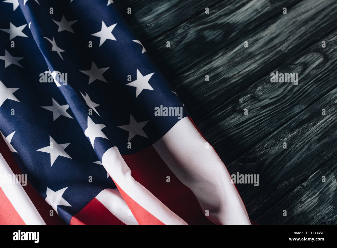 folded usa national flag on grey wooden surface, memorial day concept ...