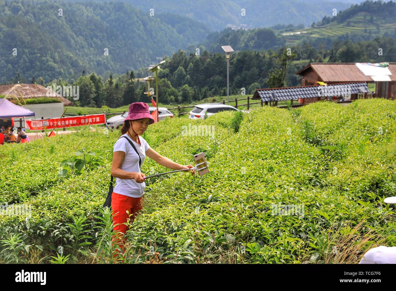Dushan, China's Guizhou Province. 8th June, 2019. A tourist takes ...