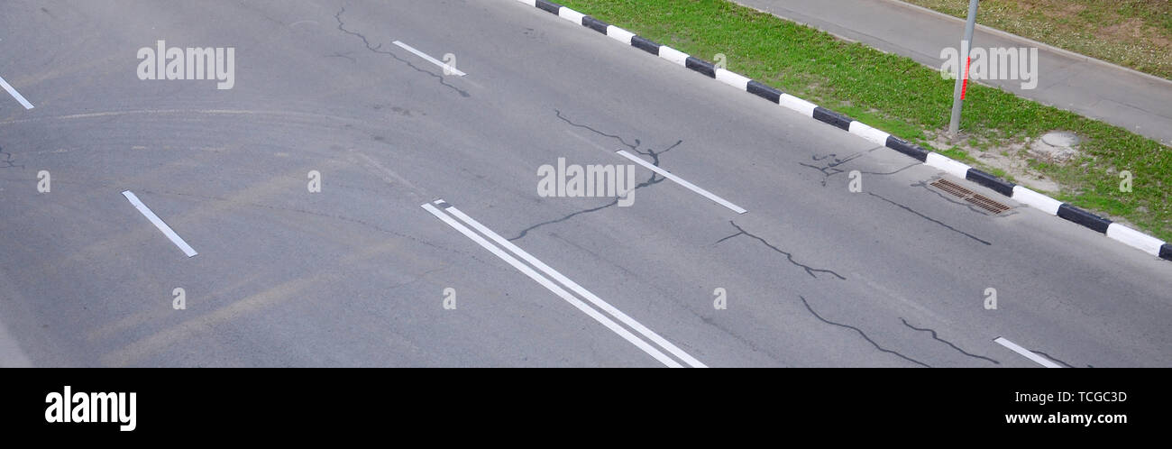 Damaged bad asphalt road with potholes. Patch repair of asphalt. Bad ...