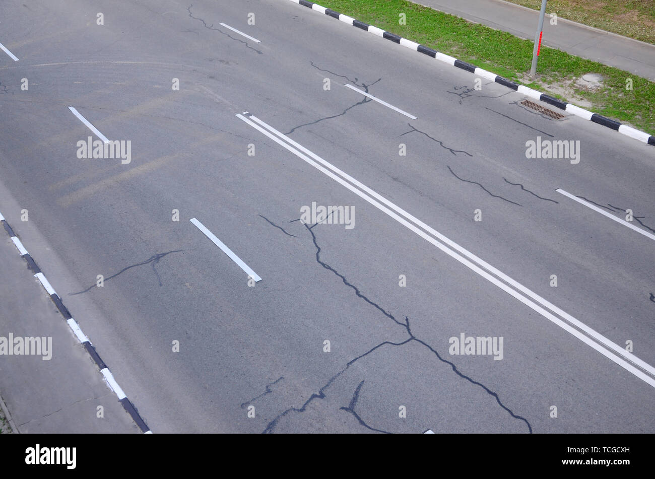 Damaged bad asphalt road with potholes. Patch repair of asphalt. Bad ...