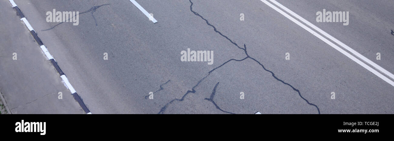 Damaged bad asphalt road with potholes. Patch repair of asphalt. Bad ...