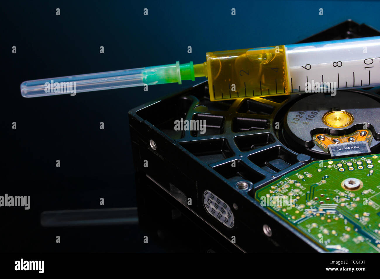 Hard disk drive on repairs on dark blue background Stock Photo - Alamy