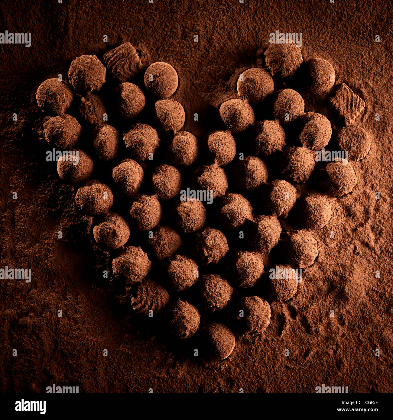 Several confectionery bonbons covered in chocolate dust lying on top of ...