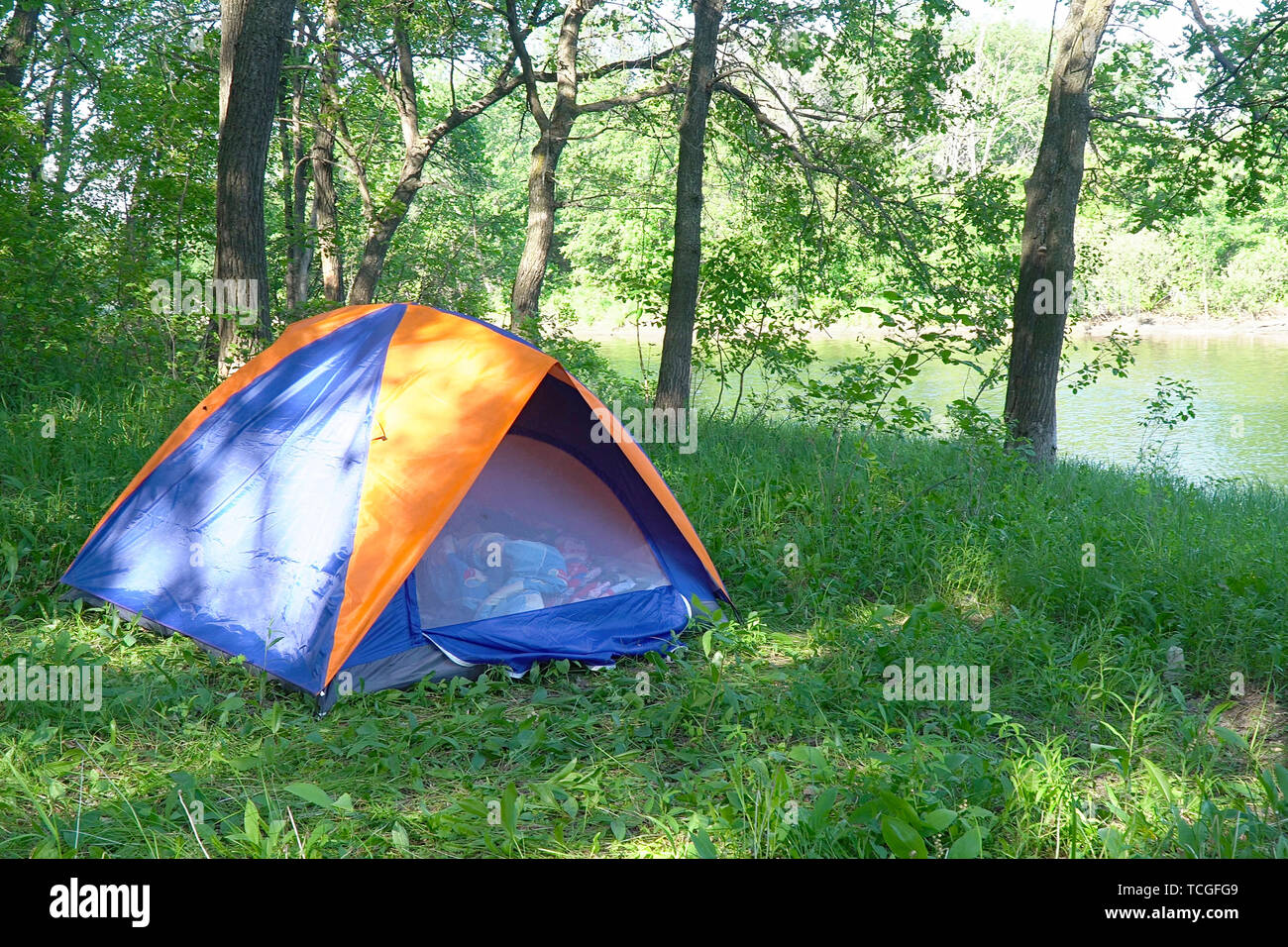 Tourist tent on the background of forest and river Stock Photo - Alamy