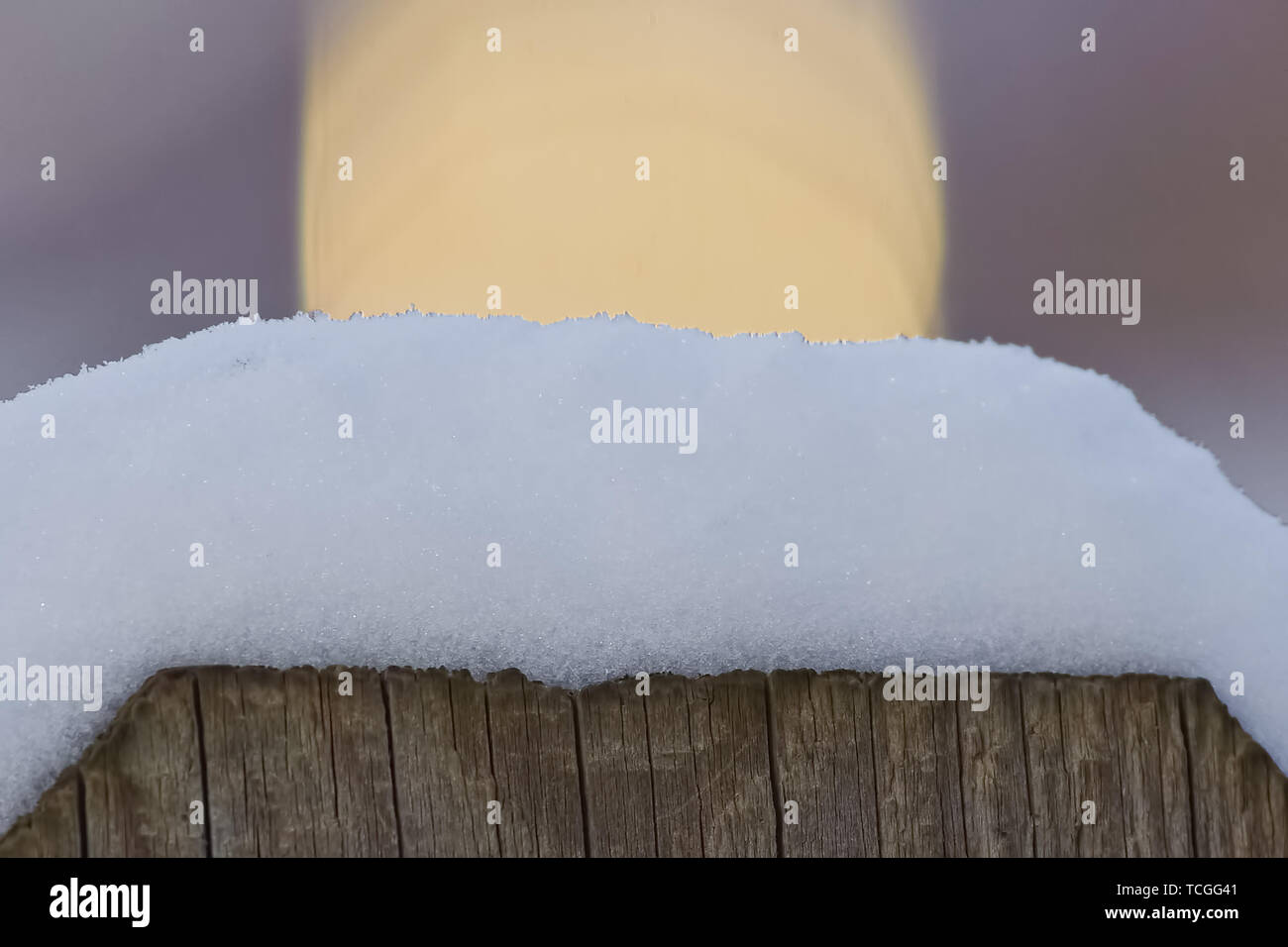 Top of snowy fence with light in the background Stock Photo - Alamy