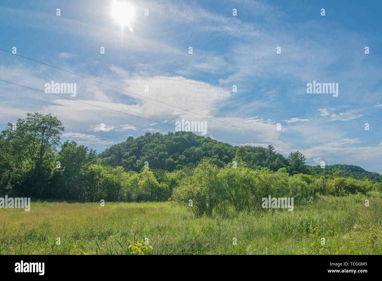 Sun on a sunny summer day in the beautiful rolling hills of driftless ...