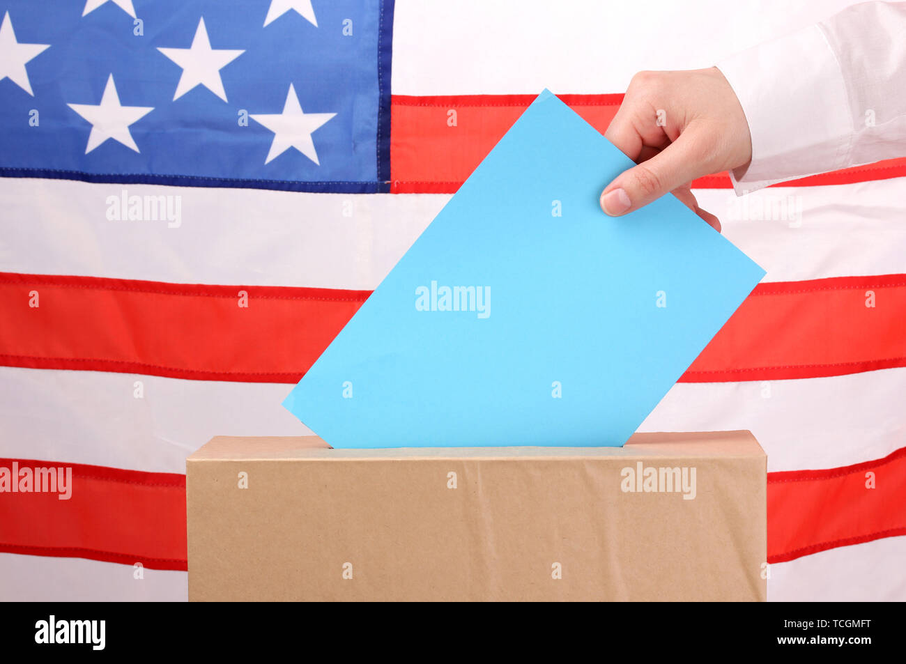Hand with voting ballot and box on Flag of USA Stock Photo - Alamy