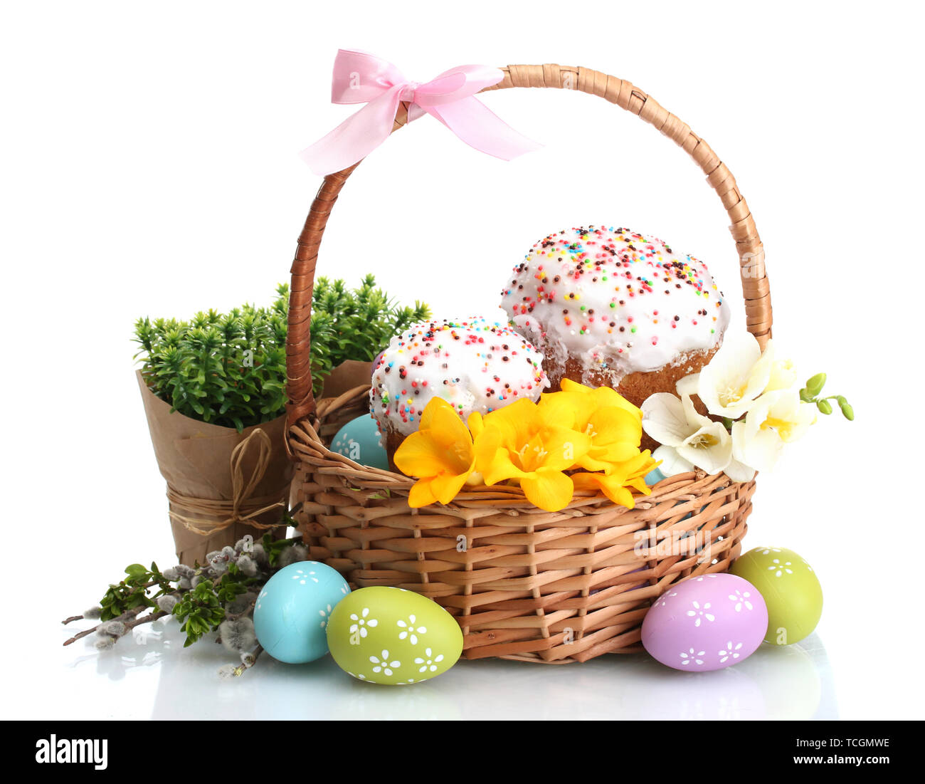 Beautiful Easter cakes, colorful eggs in basket and flowers isolated on ...