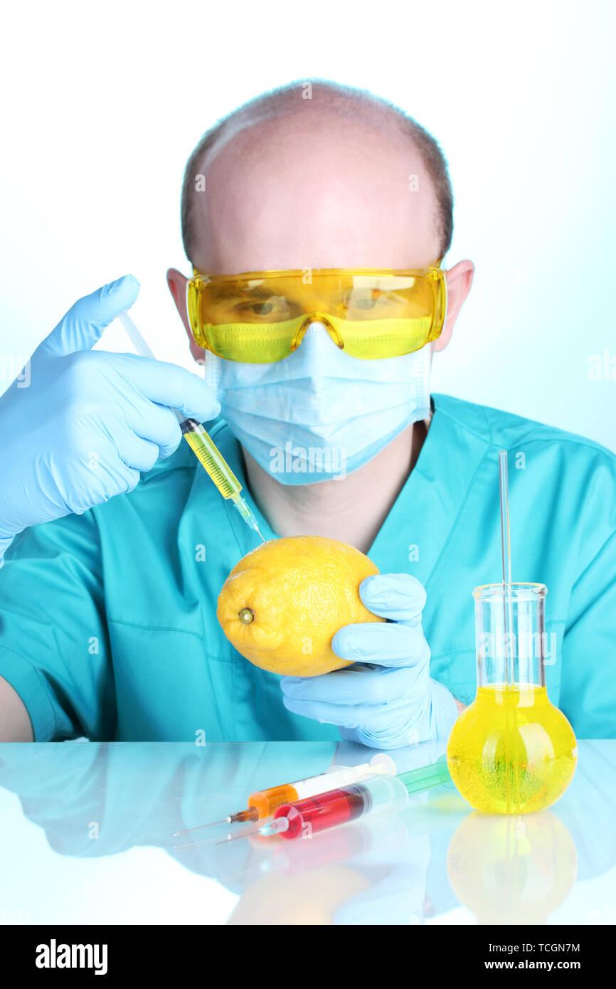 Scientist injecting GMO into the lemon Stock Photo - Alamy