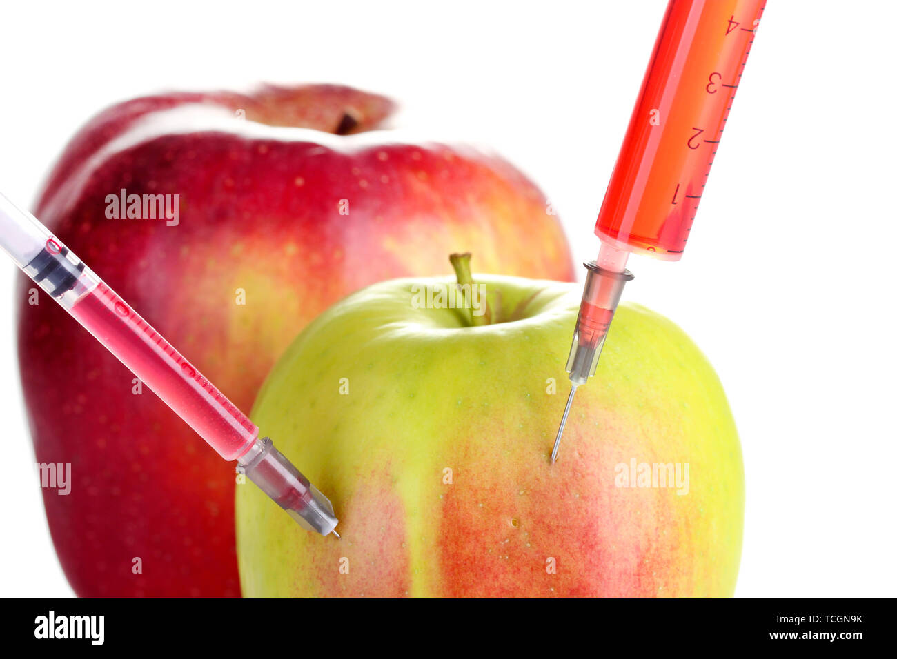 Injection into fresh apple isolated on white Stock Photo - Alamy