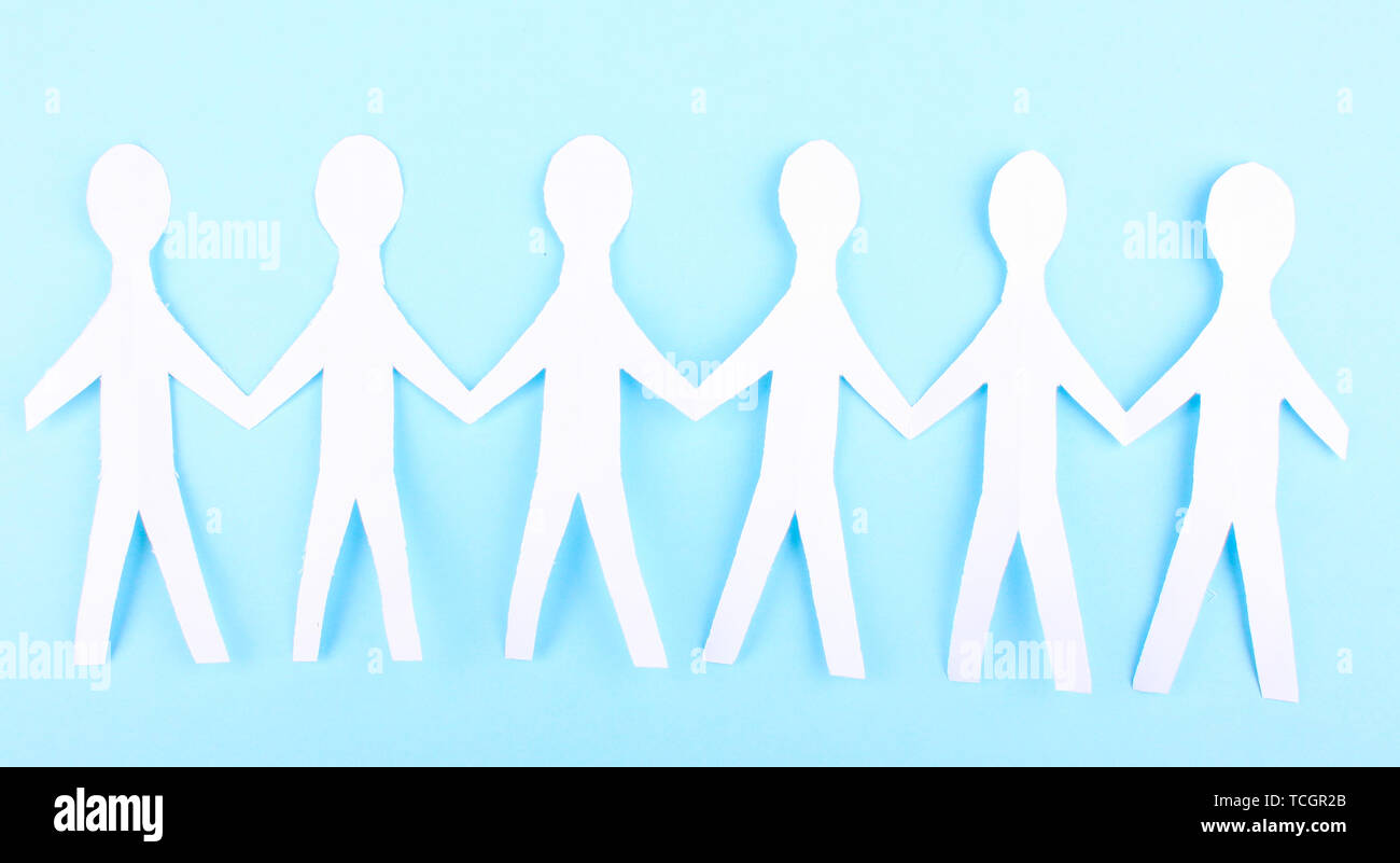 Paper people on blue background Stock Photo - Alamy