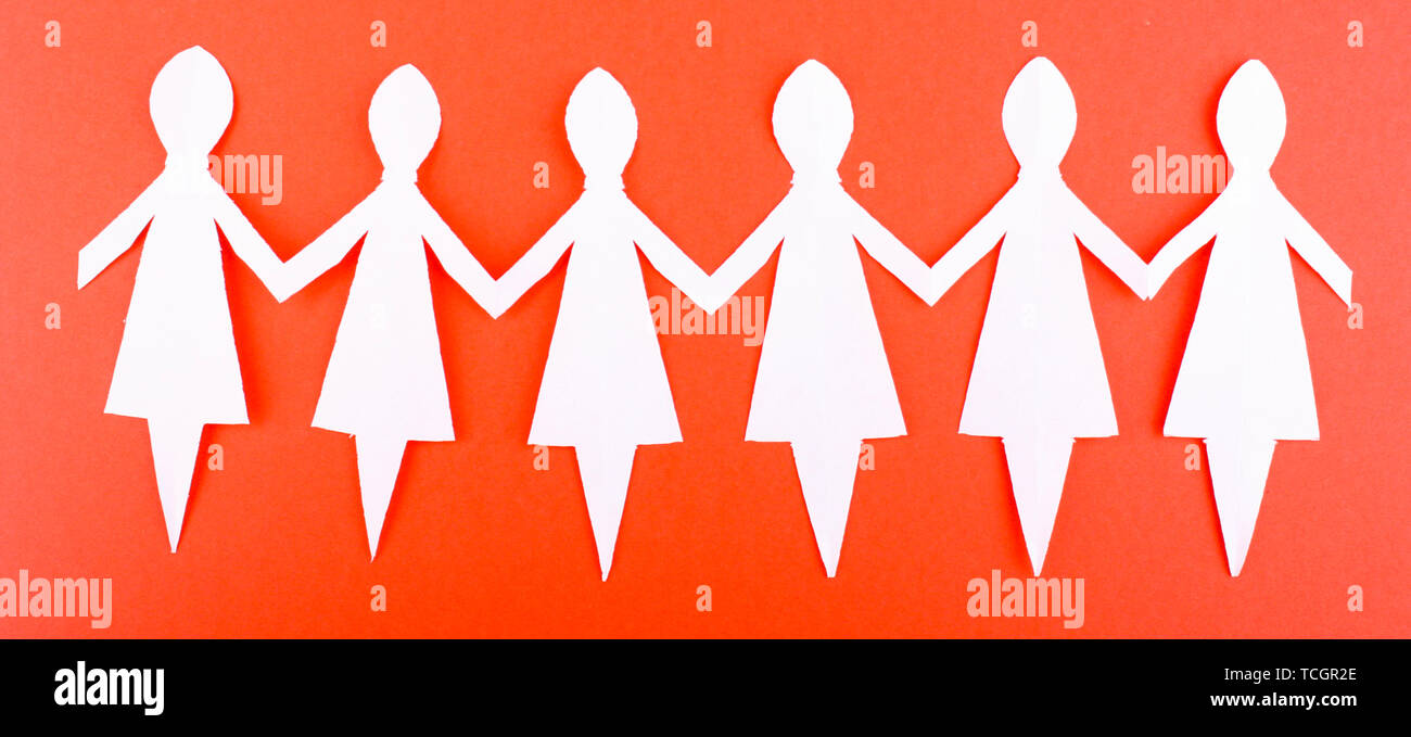 Paper people on red background Stock Photo - Alamy
