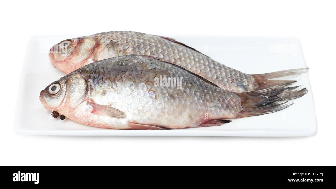 Fresh fishes on plate isolated on white Stock Photo - Alamy