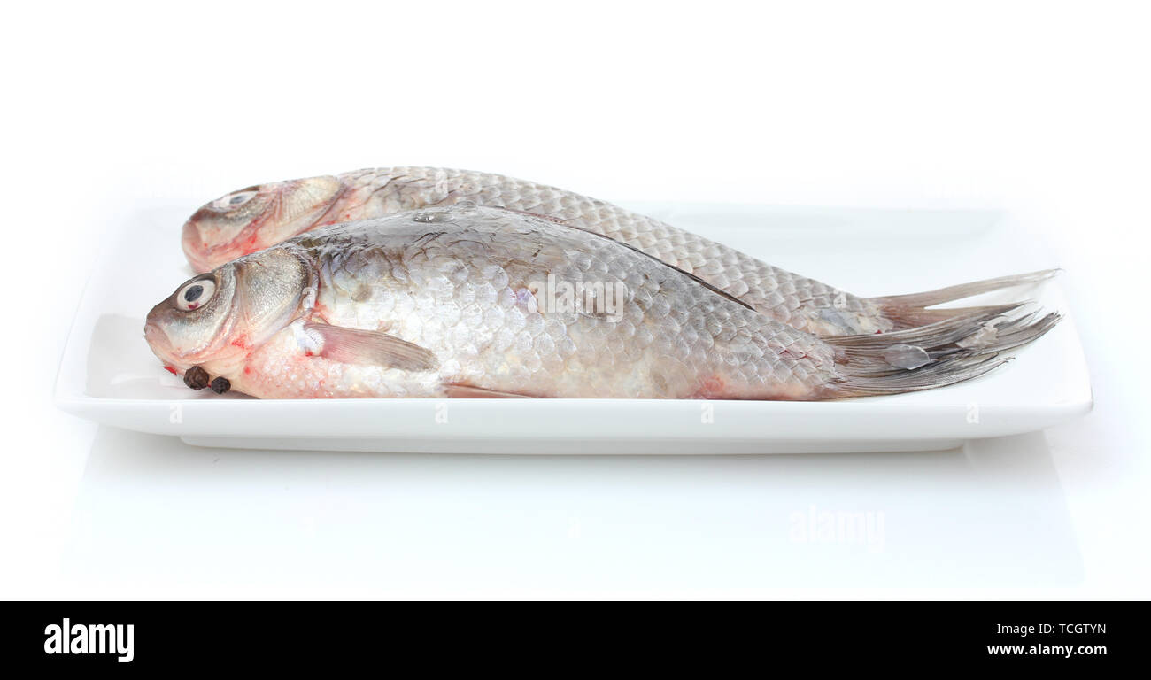 Fresh fishes on plate isolated on white Stock Photo - Alamy