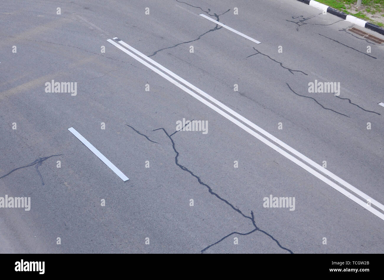 Damaged bad asphalt road with potholes. Patch repair of asphalt. Bad ...