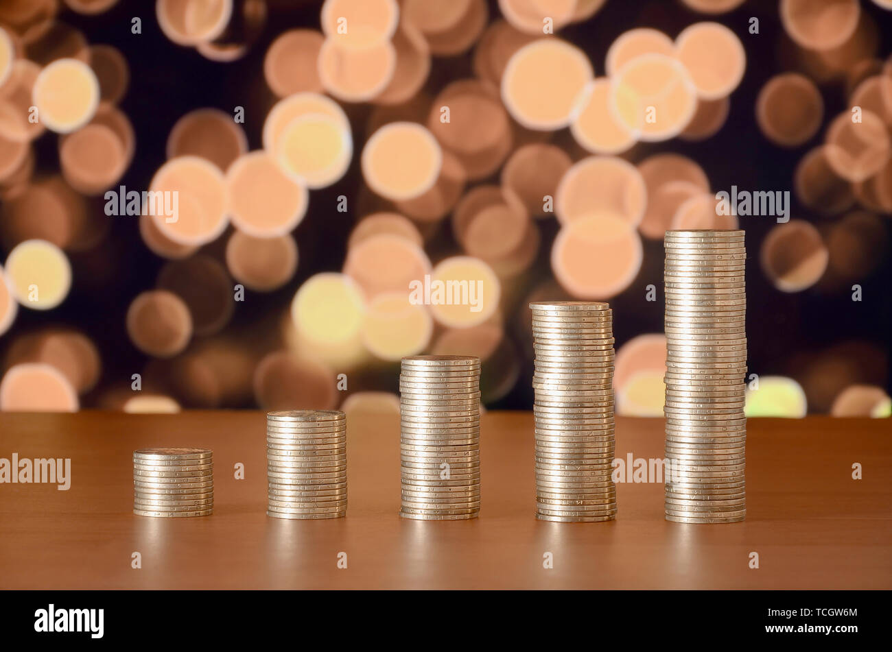 Golden coin stacks arranged as a graph. Increasing columns of coins ...