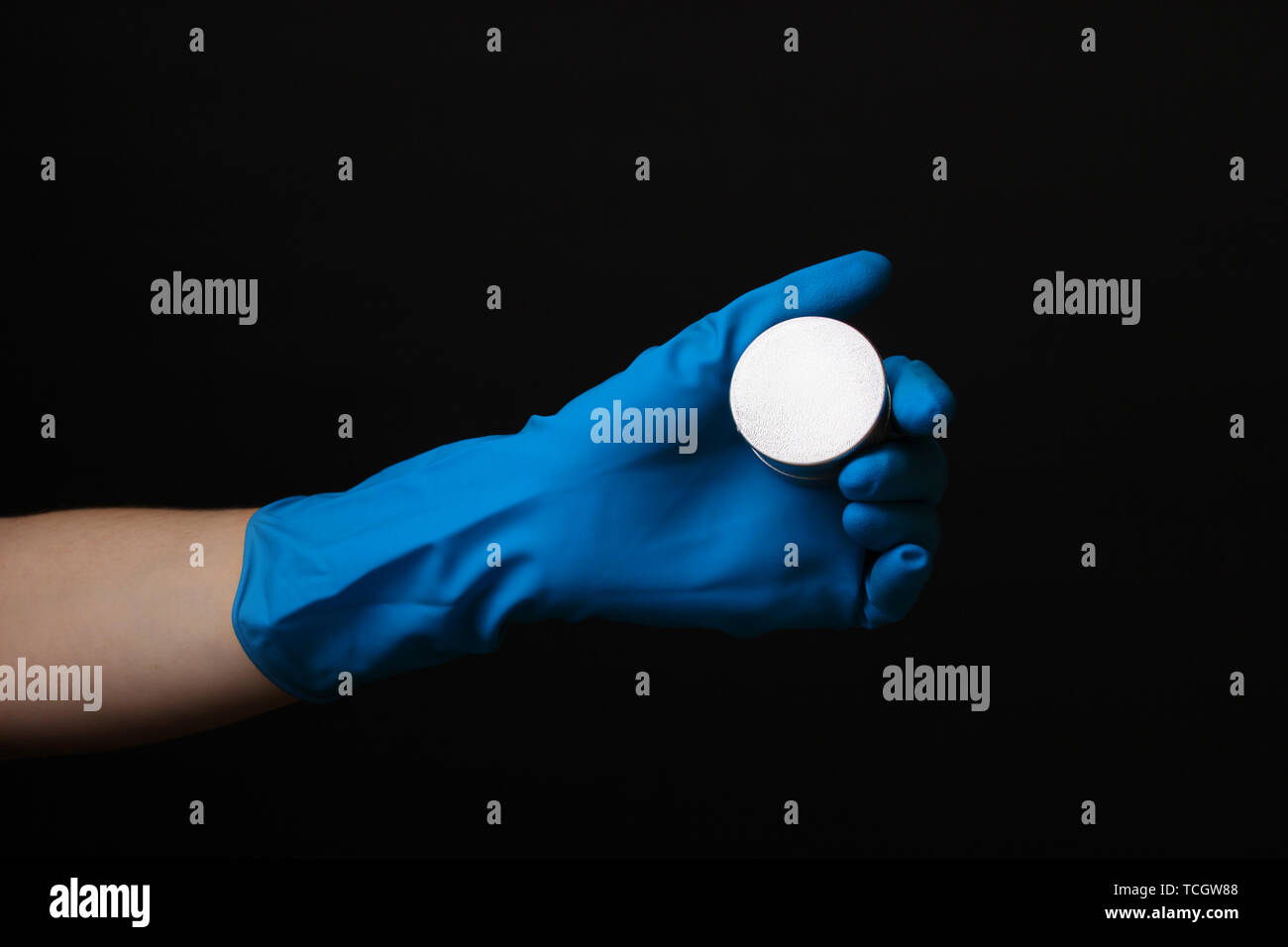 Uranium in hand isolated on black Stock Photo - Alamy