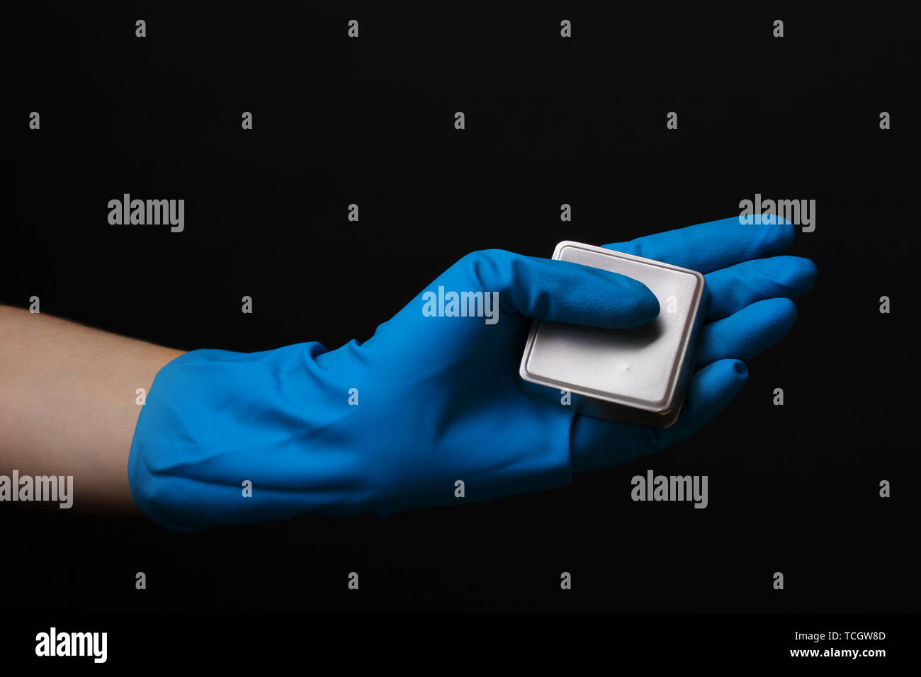 Uranium in hand isolated on black Stock Photo - Alamy