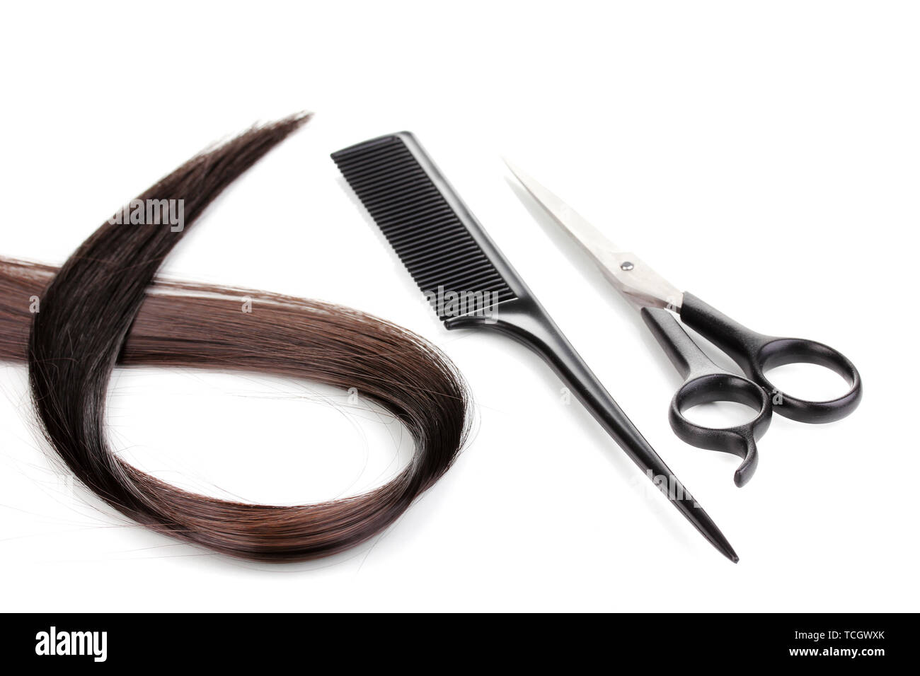 Shiny brown hair with hair cutting shears and comb isolated on white ...