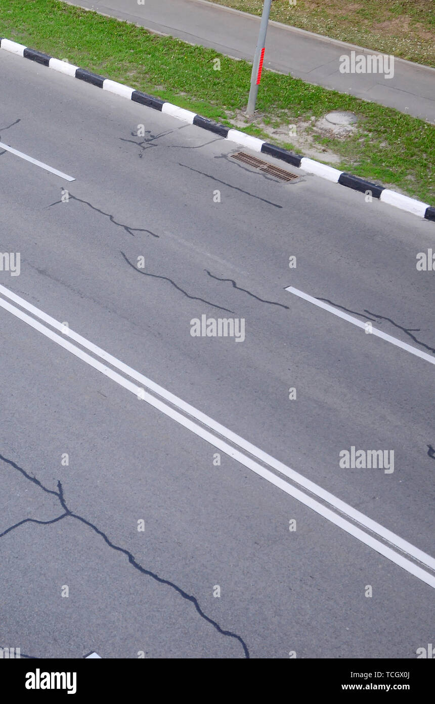 Damaged bad asphalt road with potholes. Patch repair of asphalt. Bad ...