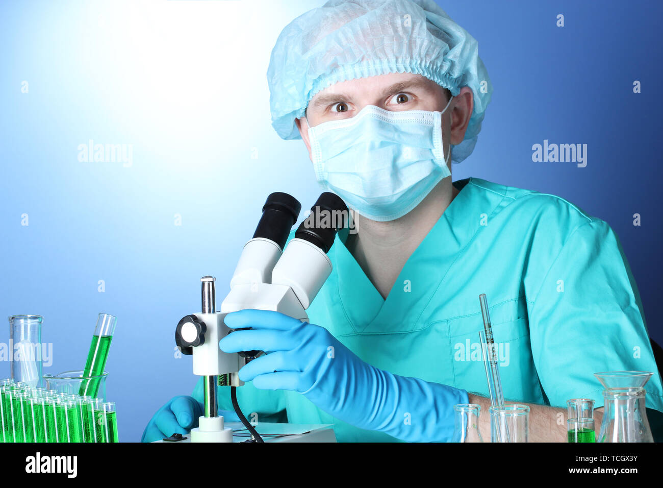 scientist looking at microscope in chemistry laboratory Stock Photo - Alamy