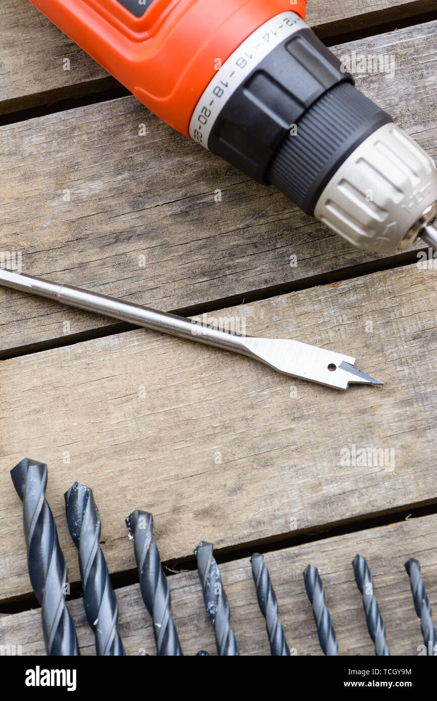 power drill and drill bits on an old wood deck Stock Photo - Alamy