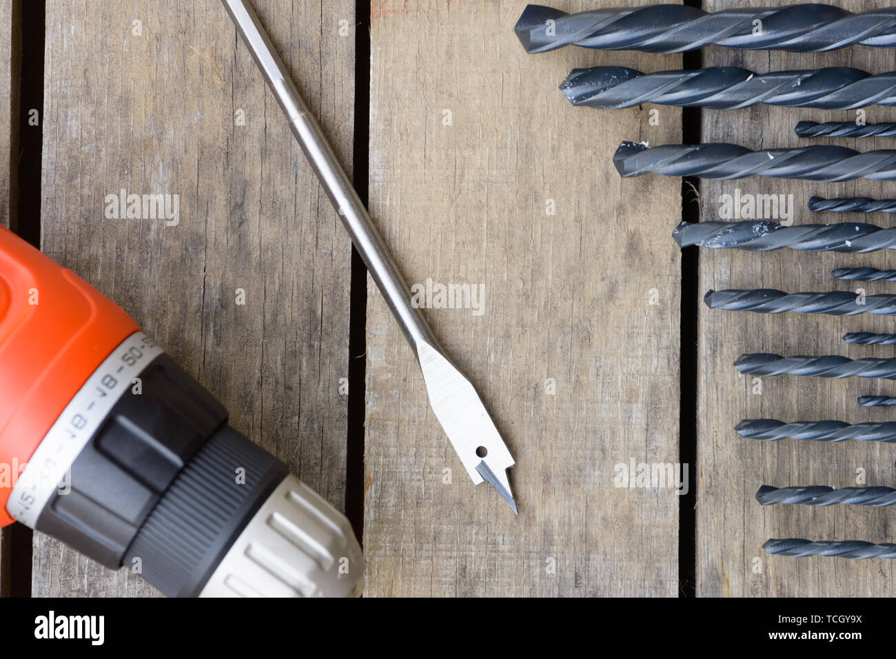 power drill and drill bits on an old wood deck Stock Photo - Alamy