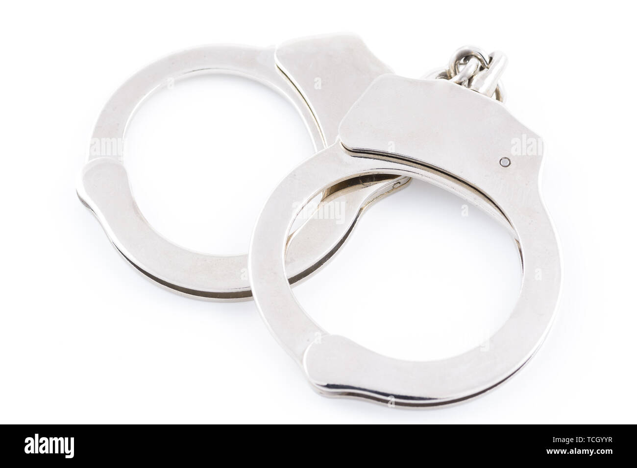 Shiny metal chrome handcuffs on a white background Stock Photo - Alamy